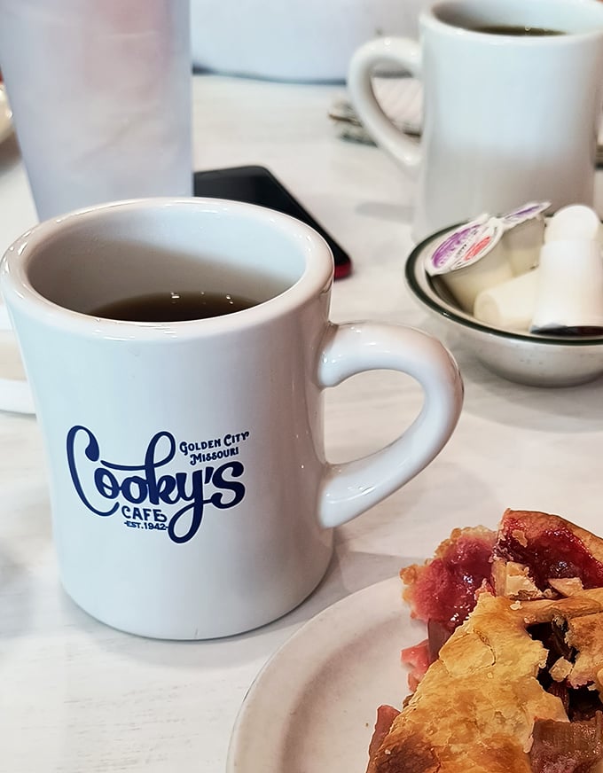 That classic white mug with a slice of cherry pie nearby—a combination more iconic than Batman and Robin, and infinitely more satisfying.