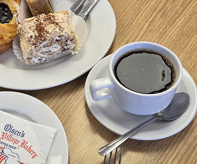 Coffee and pastry &ndash; a pairing as timeless as Bogart and Bacall, served on plates bearing the bakery's signature logo.
