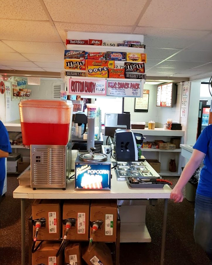 Candy, popcorn, and drinks—the holy trinity of movie snacks. That red fruit punch dispenser has probably fueled more sugar highs than a birthday party at Willy Wonka's.