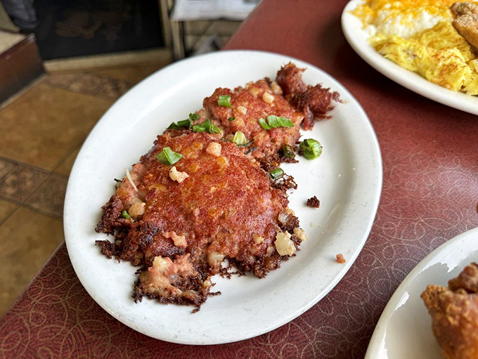 Corned beef hash with the perfect crispy edges, alongside an omelet that's clearly been made by someone who respects the humble egg.