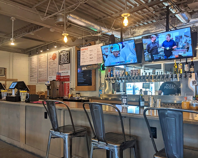 The bar area serves as command central, where craft beer flows and pizza orders are dispatched with the precision of a well-rehearsed orchestra.