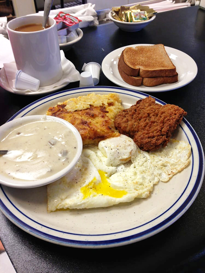 The classic breakfast trinity: eggs, hash browns, and a biscuit that could double as a fluffy cloud.