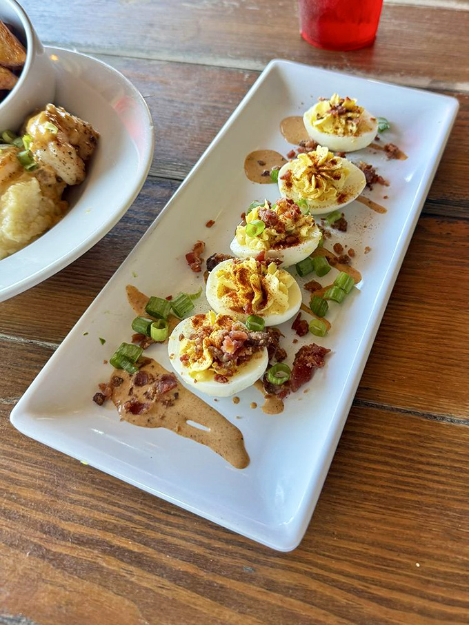 Deviled eggs gone coastal—these little boats of happiness come topped with bacon bits that would make even angels consider sinning.