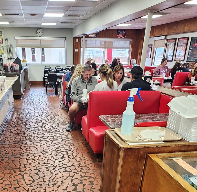 The dining room hums with the universal language of satisfaction &ndash; red booths filled with locals who know exactly why you made the drive to Lexington.