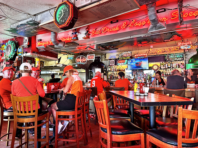 The bar area hums with the energy of people who've discovered that great food tastes even better when surrounded by the warm glow of vintage neon and cold beer.