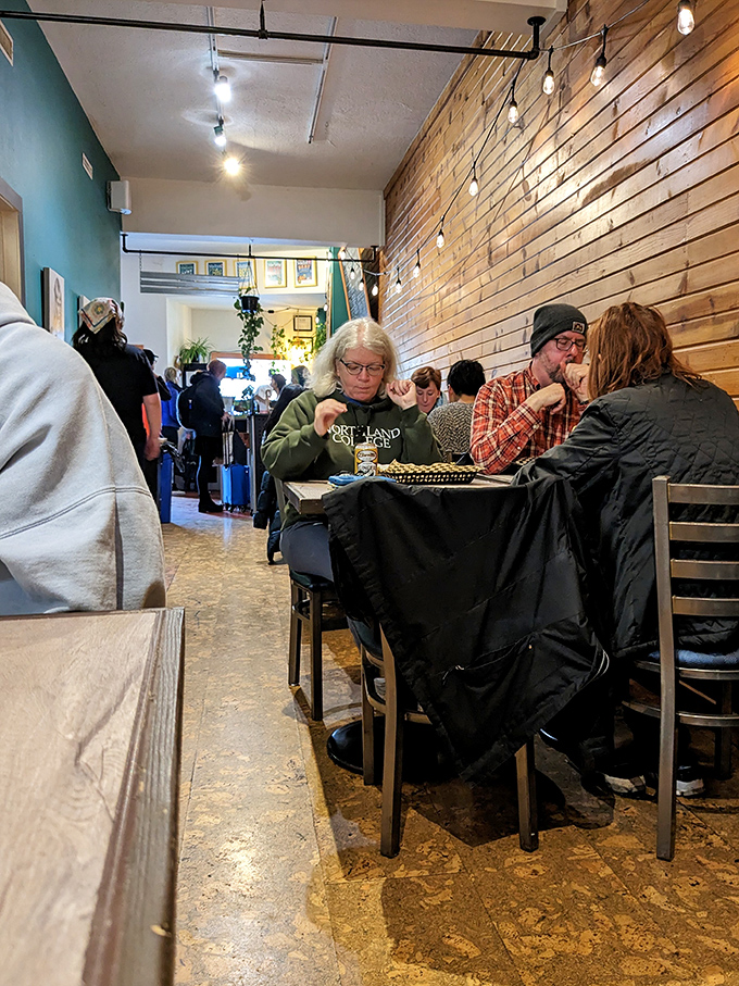 Where food becomes community. The wooden walls and string lights create the perfect backdrop for Madison's diverse diners to gather and connect.