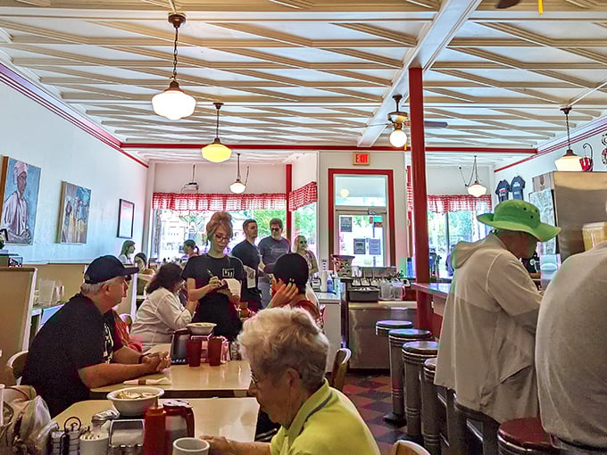 The dining room hums with the energy of a community gathering place where strangers become neighbors over coffee refills and shared maple syrup.