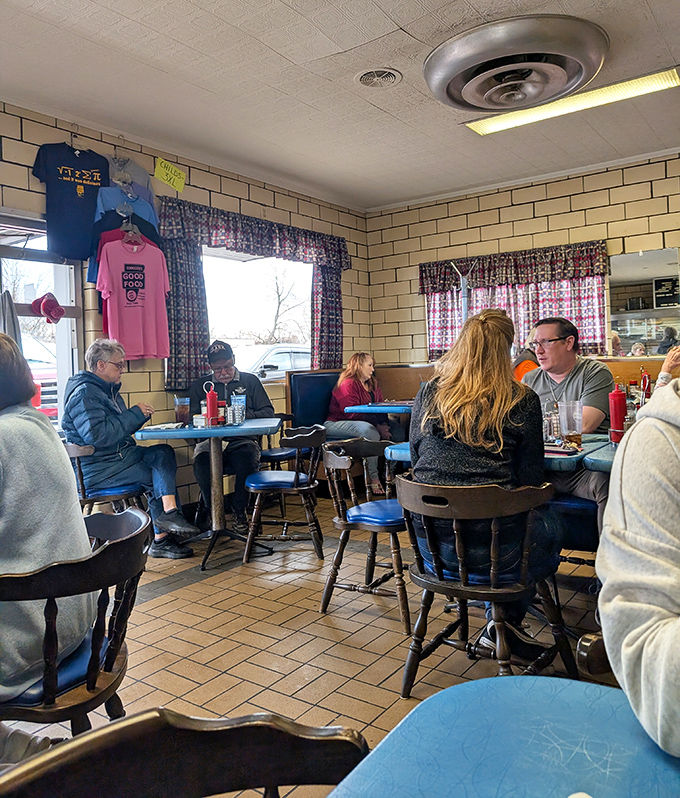 The dining room hums with conversation and clinking silverware &ndash; a community gathering spot where T-shirts hang like local battle flags.