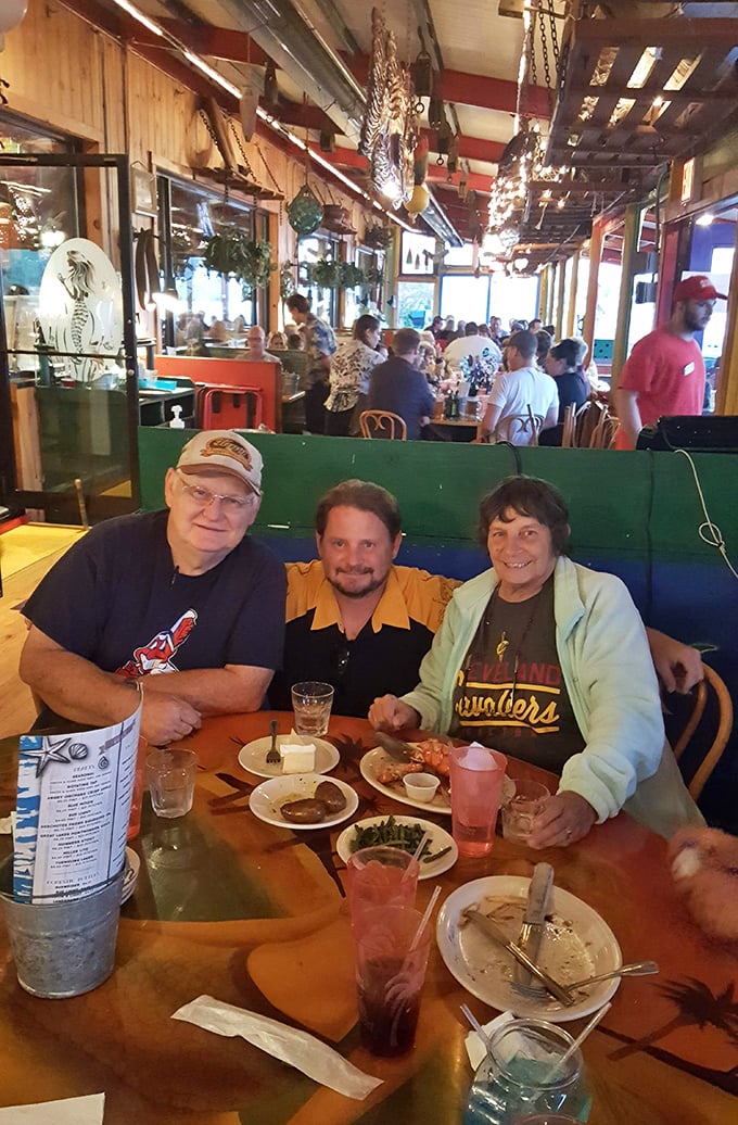 Happy diners in their natural habitat, surrounded by nautical whimsy. The empty plates tell the real story of Pickle Bill's success.