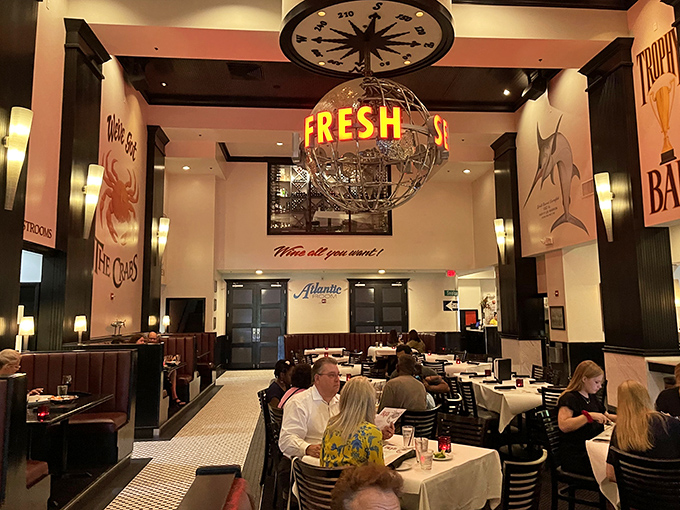 Under the watchful eye of a globe proclaiming "FRESH," diners engage in the time-honored Florida tradition of ignoring tourists while enjoying seafood. 