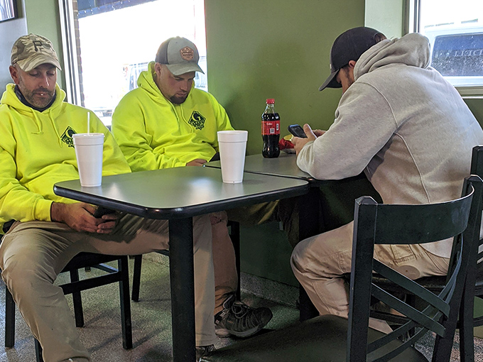 The lunchtime crowd knows the secret &ndash; these tables have witnessed countless "first bite" moments of pure sandwich bliss. Yellow hoodies optional, appetite mandatory.