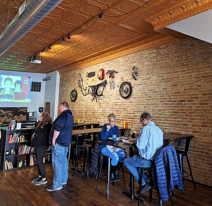 The exposed brick wall adorned with bicycle parts creates the perfect backdrop for Michigan City locals who know where to find burger nirvana.