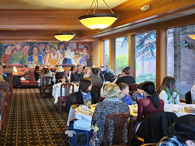 The dining room hums with the symphony of satisfaction. That mural in the background has witnessed thousands of "mmm" moments.