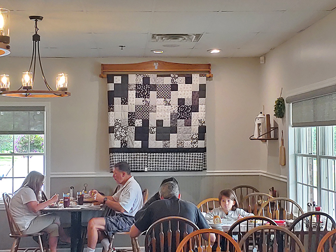 Families connecting over meals instead of screens. That quilt on the wall has probably witnessed more genuine conversations than most therapists.