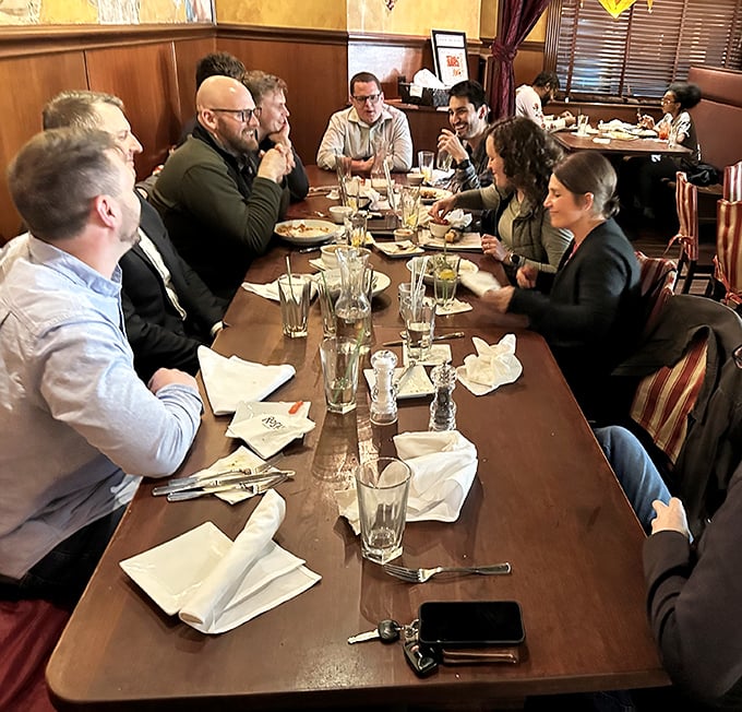 Good food brings people together. This long table of diners isn't just eating&mdash;they're creating memories that will outlast the meal itself.