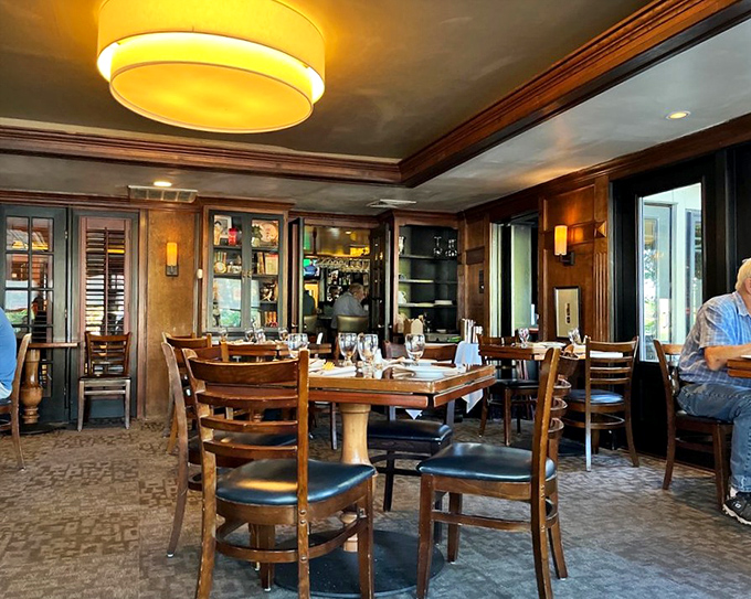 The dining room's rich wood paneling and soft lighting create an atmosphere where every meal feels celebratory.