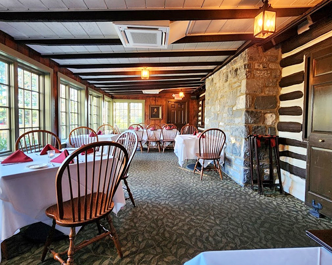 Windsor chairs and white tablecloths against original log walls create that perfect "rustic elegance" that interior designers spend careers trying to replicate.