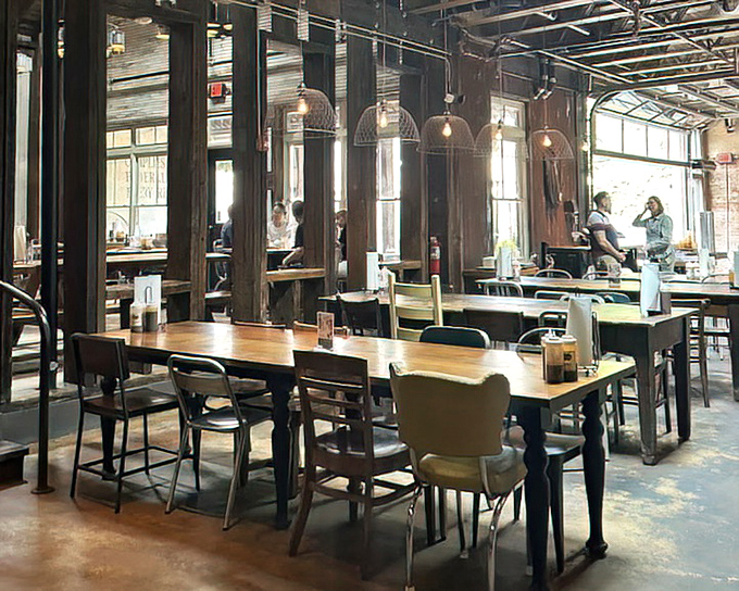 The industrial-chic interior where strangers become friends over shared tables and the mutual understanding that barbecue sauce stains are badges of honor.