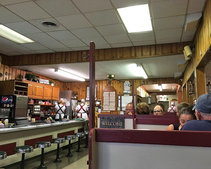 The dining room's wood paneling and booth dividers aren't retro by design—they're authentic survivors from a time when conversations trumped cell phones.