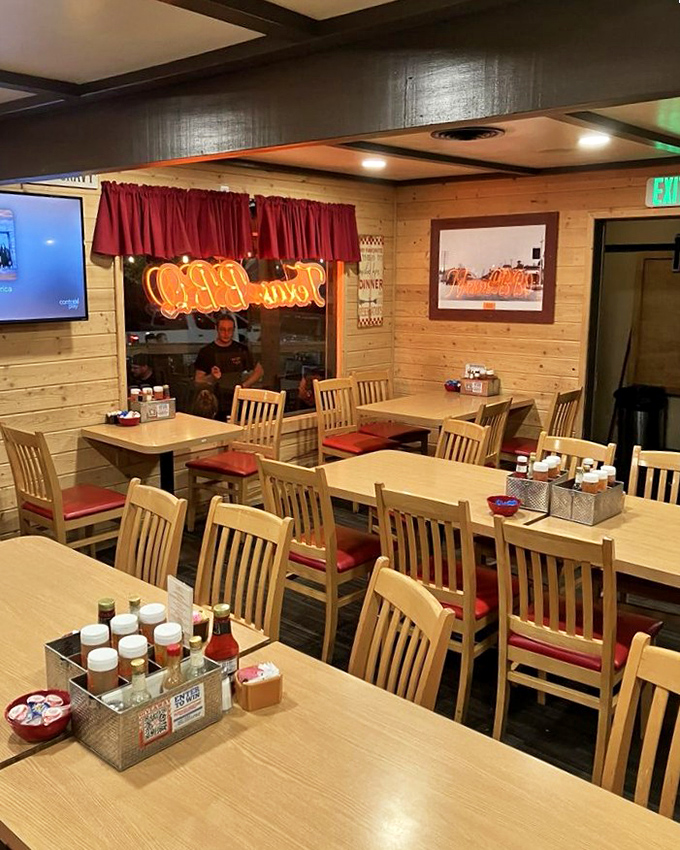 The dining room feels like grandma's kitchen got an upgrade &ndash; wood paneling, red cushions, and condiment caddies that have witnessed countless coffee refills.