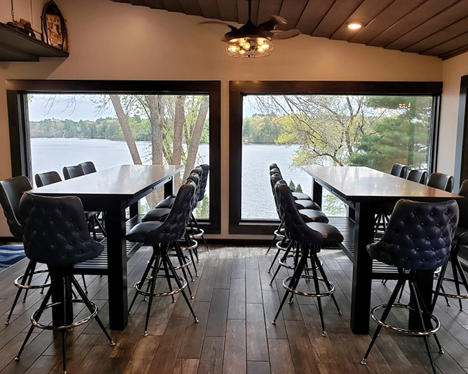 These high-top tables by floor-to-ceiling windows aren't just seats; they're front-row tickets to Lake Wissota's ever-changing natural show.