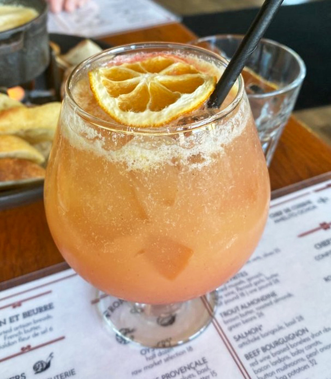 A cocktail that says, "Yes, you deserve this little vacation in a glass." That dehydrated citrus wheel is just showing off.