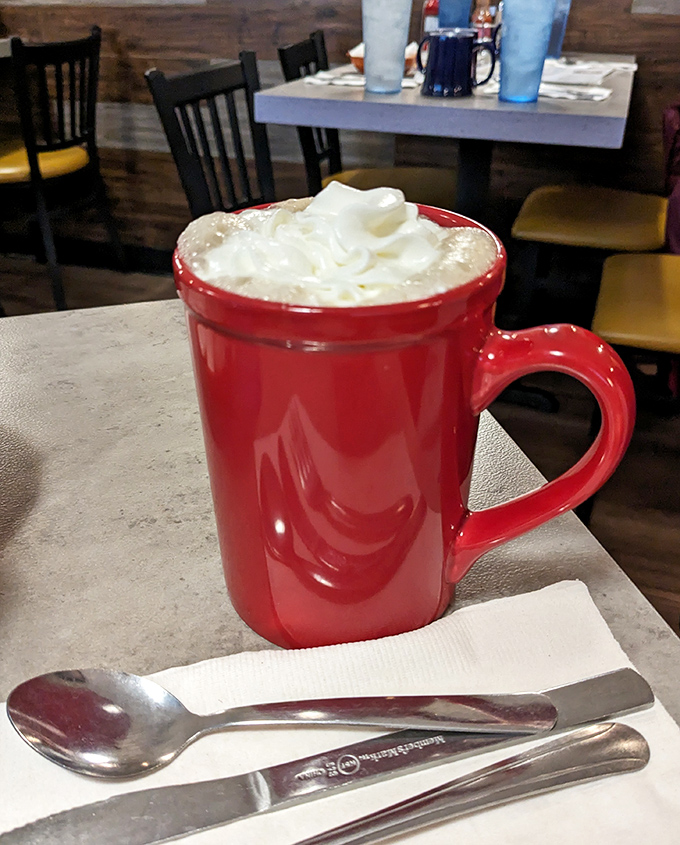 That red mug isn't just serving hot chocolate; it's delivering a warm hug in liquid form, complete with whipped cream hat.