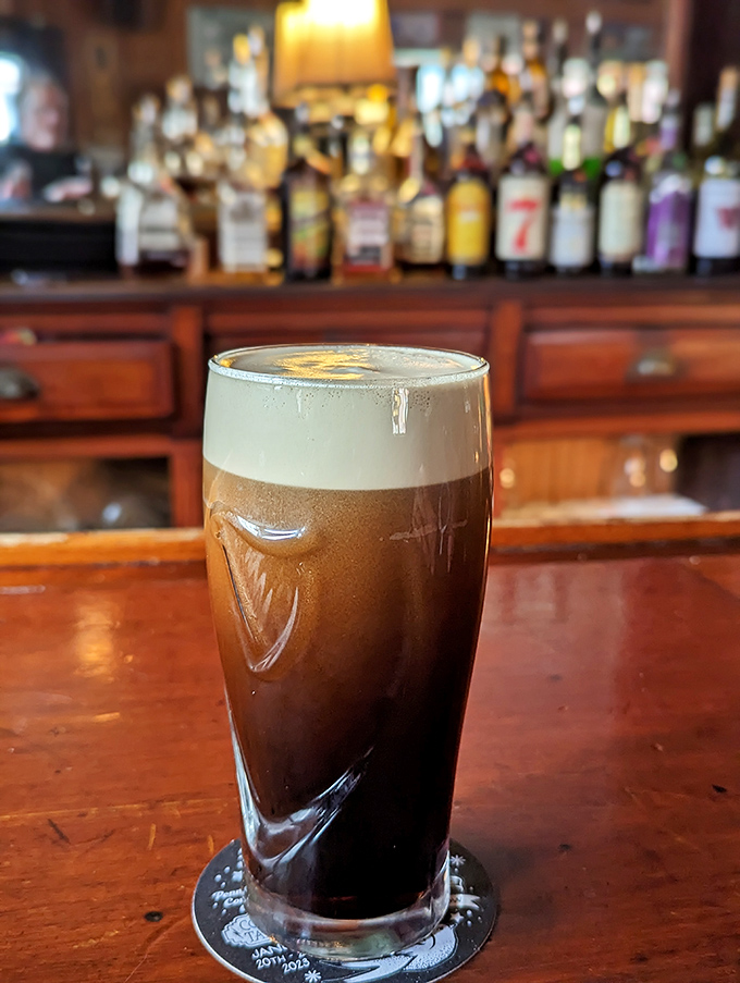 A properly poured pint with that perfect head—the kind that makes you want to solve all the world's problems over drinks.