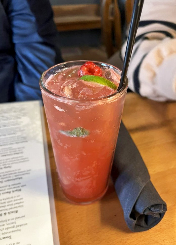 A raspberry cocktail that looks like summer in a glass. The lime and fresh berry garnish aren't just pretty&mdash;they're promising you refreshment.