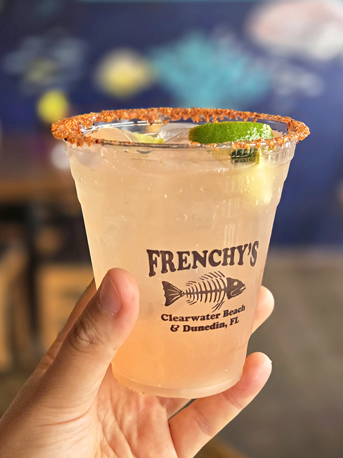A perfectly salted rim frames this refreshing cocktail like a halo. Nothing says "vacation mode activated" quite like a cold drink with the Frenchy's fish skeleton logo.