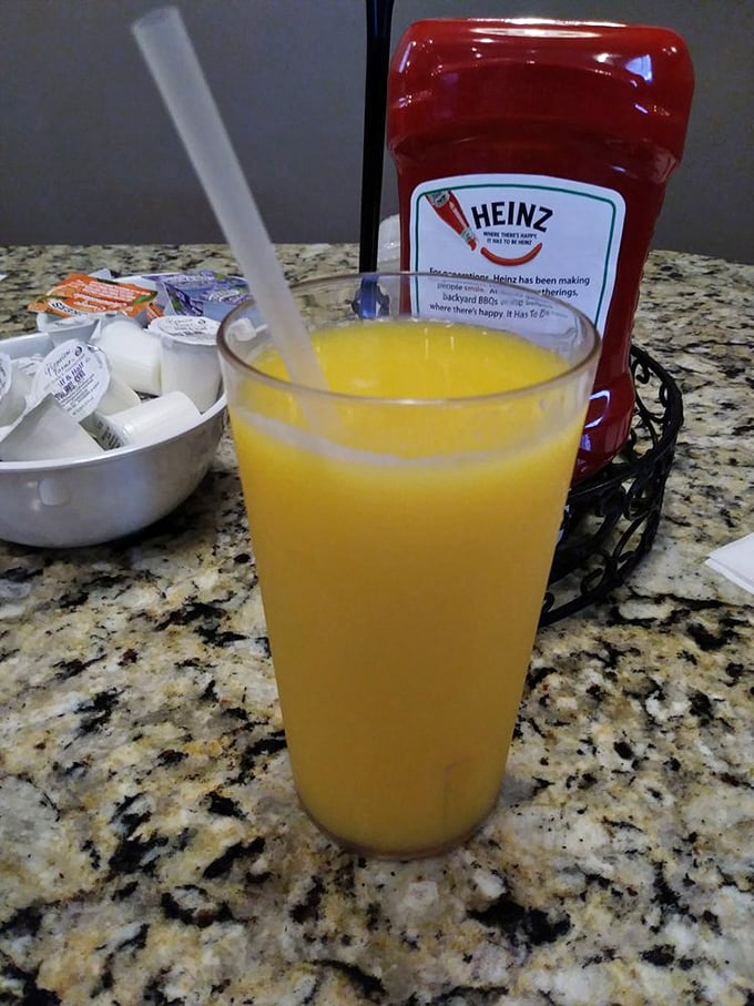 That orange juice looks fresher than morning dew. In the background, condiments stand ready for their supporting roles in your breakfast drama.