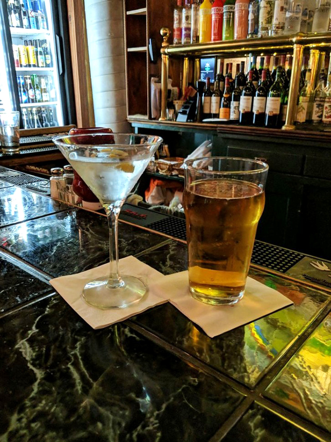 The perfect Irish pub pairing: a crisp, golden beer alongside something sophisticated in a martini glass. One says "relax," the other says "but stay interesting."
