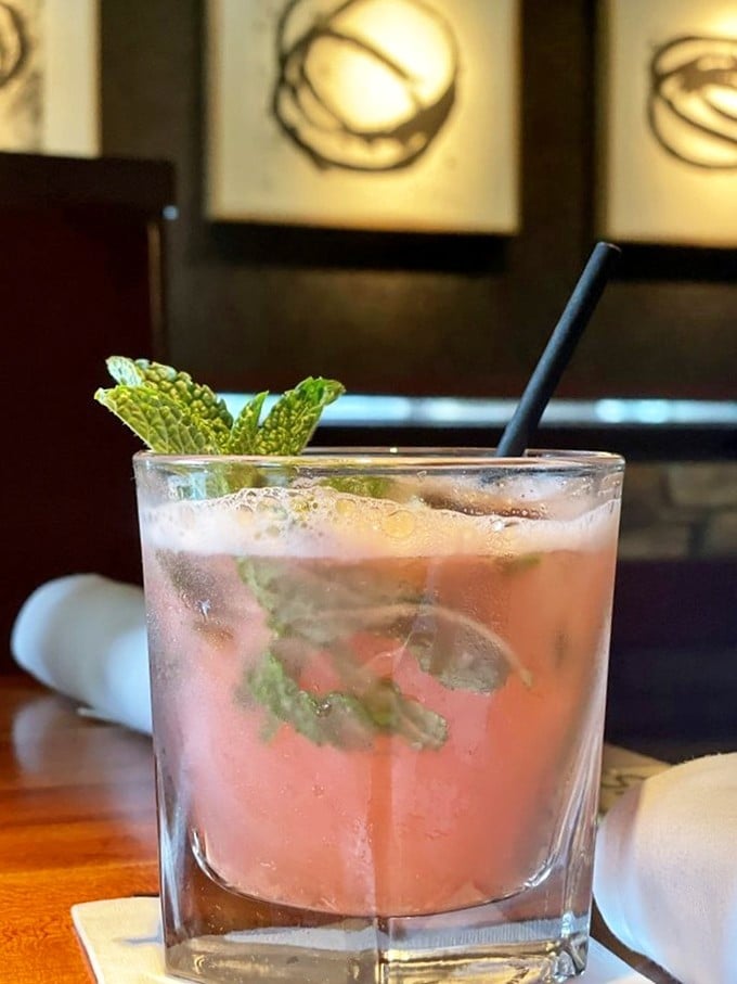 A cocktail garnished with fresh mint that says, "Yes, you deserve this moment of Florida bliss after battling that I-95 traffic."
