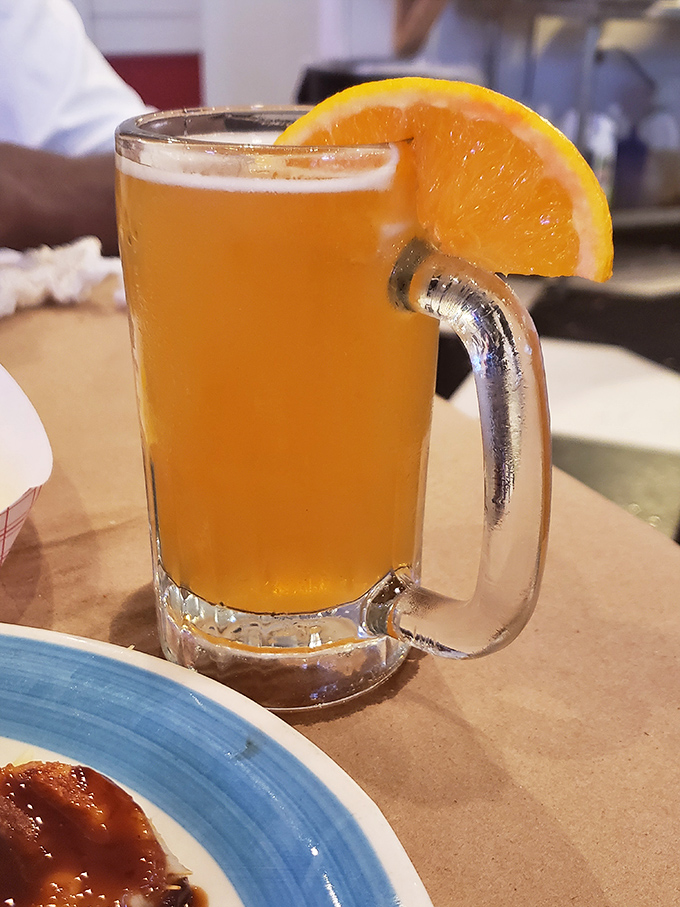 This beer, golden as a summer sunset and garnished with orange, isn't just a drink&mdash;it's liquid vacation in a frosty mug.