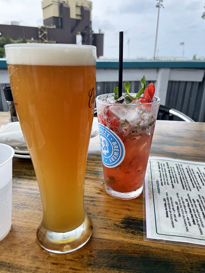 Craft beer and a strawberry cocktail that's practically wearing a tiny umbrella and sunglasses. Vacation in a glass, no passport required.