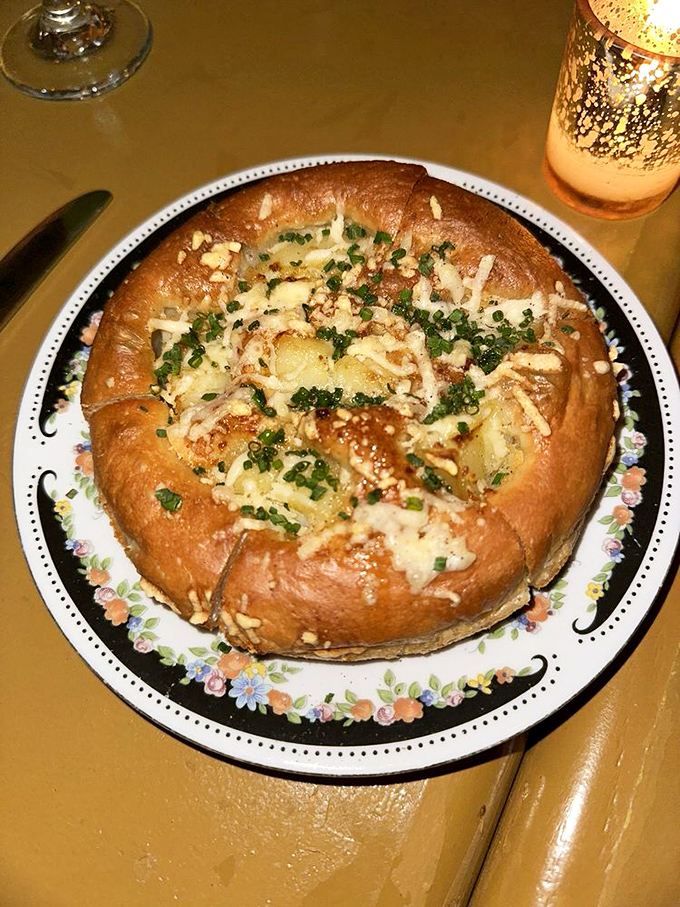 This isn't just bread&mdash;it's a pillowy focaccia island floating in a sea of melted cheese and herbs, begging to be torn apart by eager hands.
