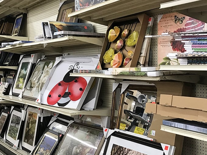 Framed art pieces wait patiently to transform blank walls into personal galleries at garage sale prices.