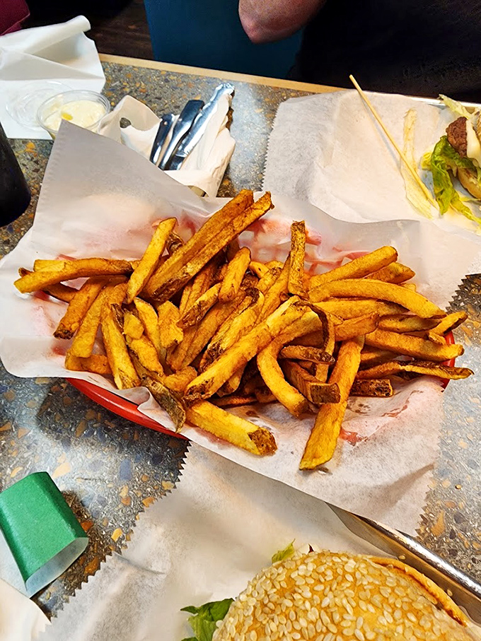 Hand-cut fries with personality: some crispy, some soft, all delicious. The potato equivalent of a perfect jazz ensemble. 