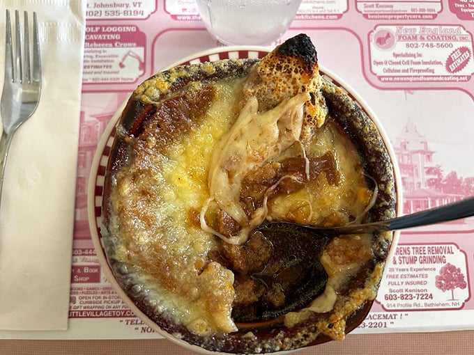Bubbling cheese creating that perfect crown on French onion soup&mdash;the kind of simple perfection that makes you temporarily forget your table manners.