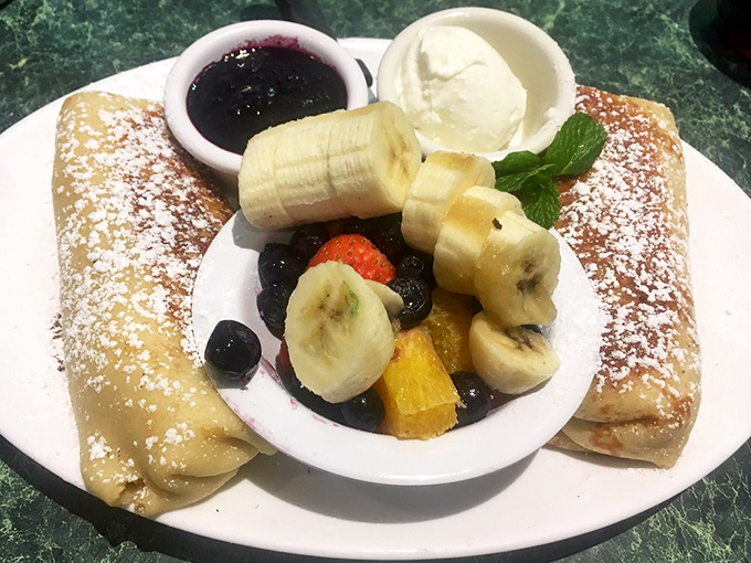 Breakfast crepes that understand fruit isn't just healthy&mdash;it's dessert in disguise. That powdered sugar snowfall seals the deal.