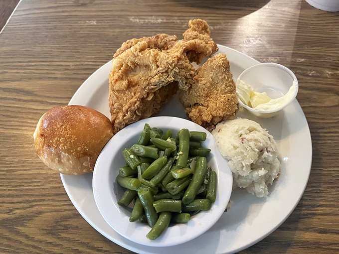 Southern fried chicken with green beans and potato salad. This plate doesn't need a filter&mdash;it's the original comfort food influencer.