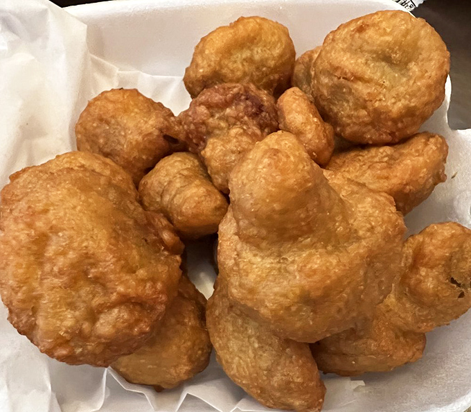 Fried mushrooms that achieve the impossible &ndash; maintaining their earthy essence while wearing a perfectly seasoned golden armor of crispy batter.
