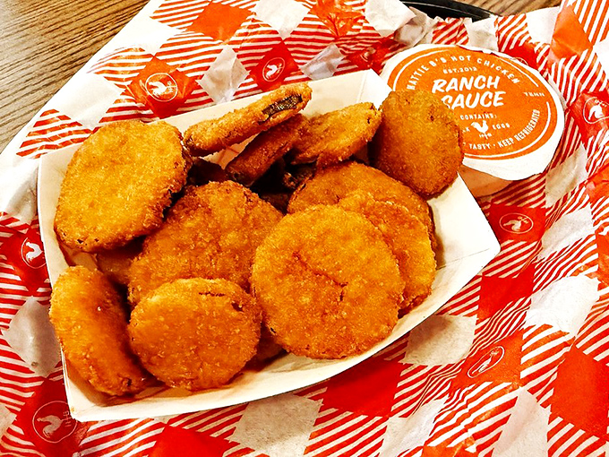 Golden fried pickles arrive like crispy little life preservers in your sea of spice.
