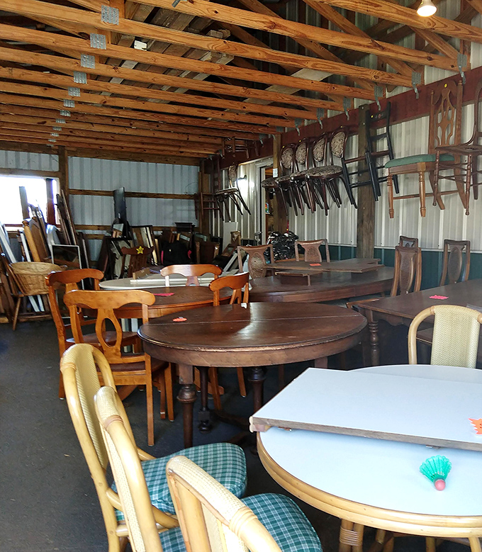 Solid wood dining tables with stories to tell, arranged in the warehouse like a furniture family reunion.