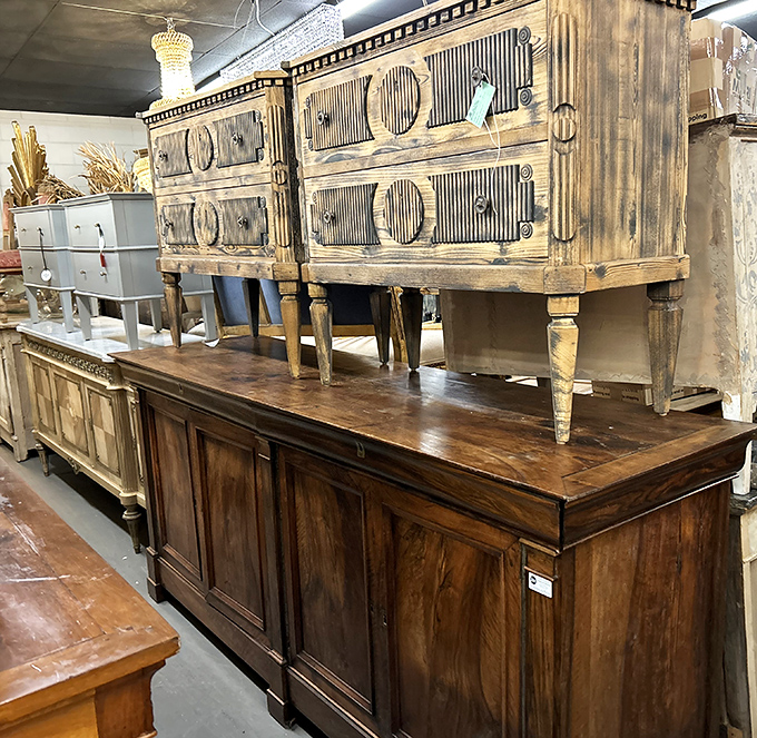 Weathered wood meets elegant design in this furniture display. These aren't just dressers and cabinets&mdash;they're time capsules with drawers.