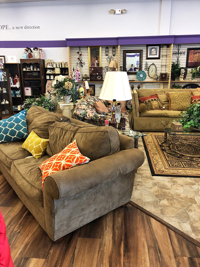 Living room goals that won't require a second mortgage. Those accent pillows add the perfect pop of color to neutral sofas that have plenty of life left.