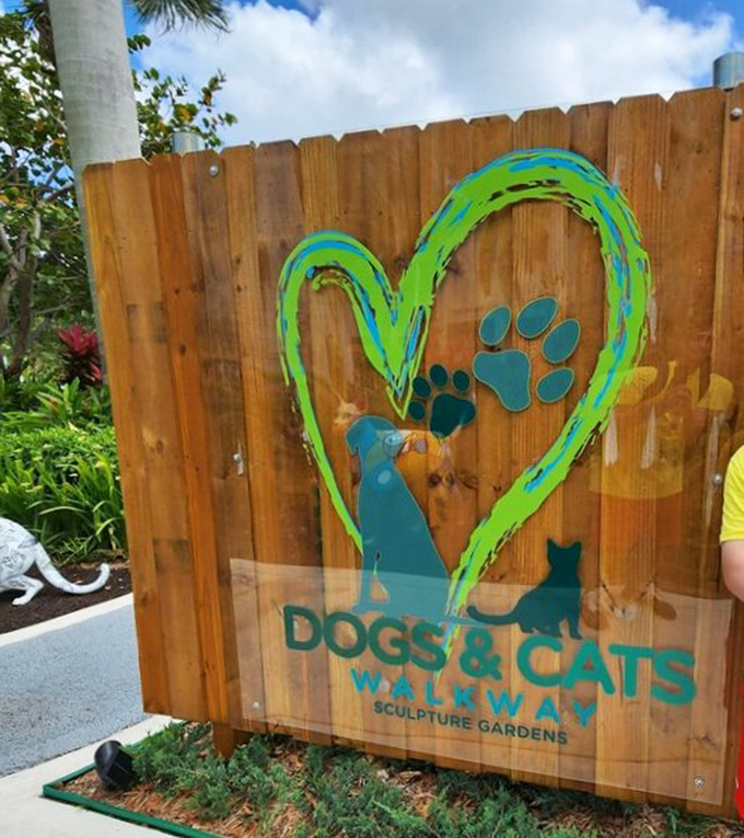 The garden's charming wooden sign welcomes visitors with a heart-shaped logo. A perfect introduction to this pet-lover's paradise.