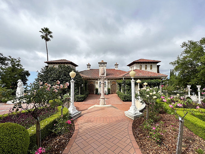 A garden path lined with marble columns and blooming roses &ndash; because when you're this wealthy, even your walkways deserve architectural significance.