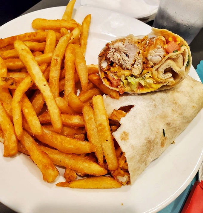 This wrap isn't just holding ingredients&mdash;it's cradling dreams. Golden fries standing by like loyal friends ready to complete your happiness.