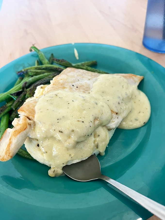 Herb-roasted chicken draped in velvety sauce alongside vibrant green asparagus &ndash; proof that diners can do elegant without pretension.